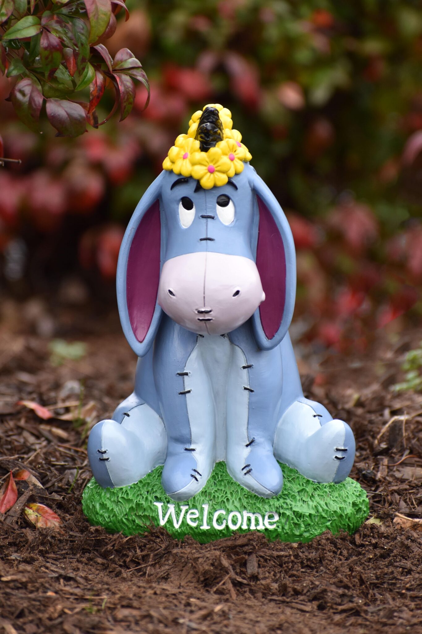 Buy: Eeyore Daisy Crown 10″ Garden Statue Spring Flagology.com